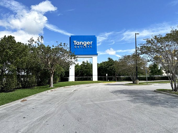 Tanger Outlets' impressive white facade gleams in the sunlight, a temple dedicated to the art of the perfect purchase.