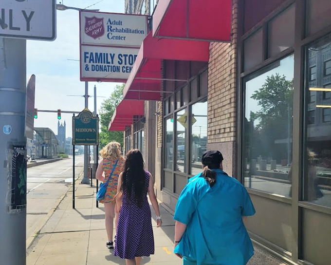 People walking toward Salvation Army's storefront, drawn like moths to the flame of fantastic secondhand finds.