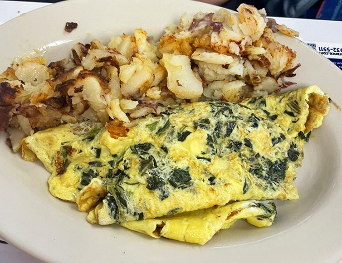 This isn't just an omelet&mdash;it's a masterpiece of morning engineering with vegetables folded into fluffy eggs alongside crispy potatoes.