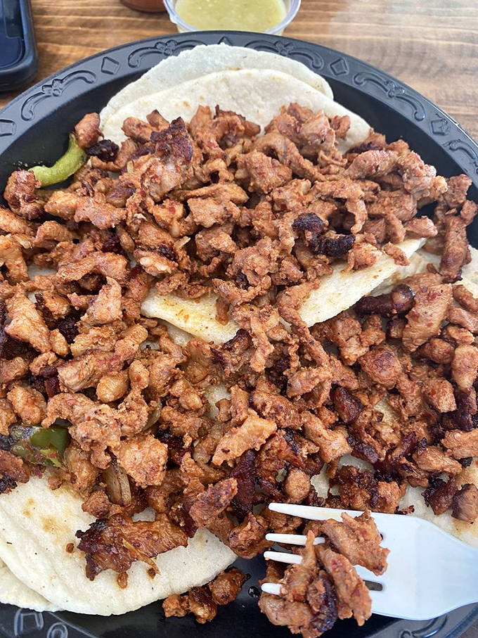 These adobada tacos aren't just food; they're tiny flavor festivals where spiced pork is the headlining act and the tortillas are the perfect venue.