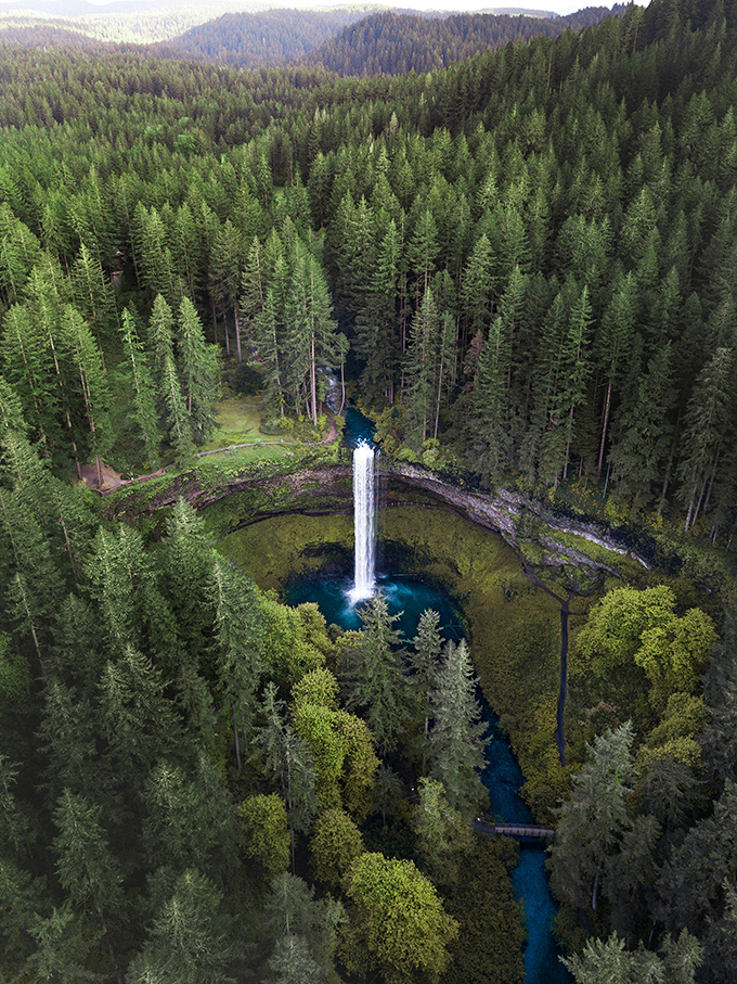 The ultimate bird's-eye view: From above, this waterfall looks like Mother Nature dropped a perfect sapphire into a crown of emerald forest.