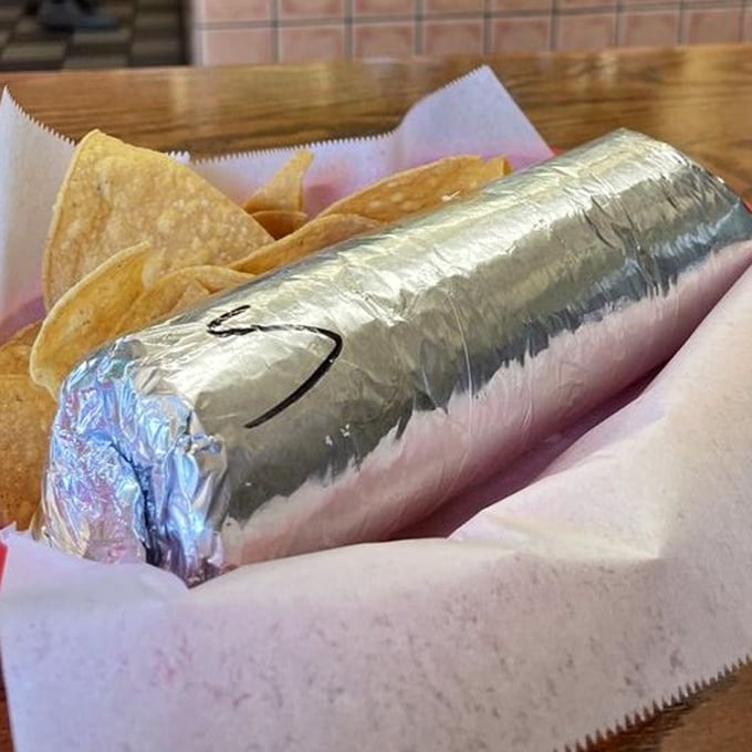The silver-wrapped burrito&mdash;like a present your stomach has been waiting for all day. The chips are just the bow on top.