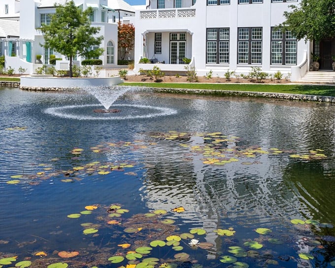 A serene fountain creates nature's soundtrack in this community gathering space, where lily pads float like tiny islands of tranquility in retirement paradise.