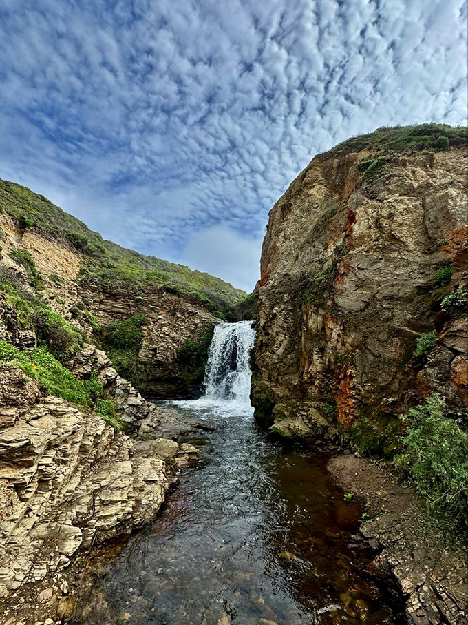 Hidden between coastal cliffs, this upper cascade is the appetizer before the main course &ndash; a preview of watery wonders to come.