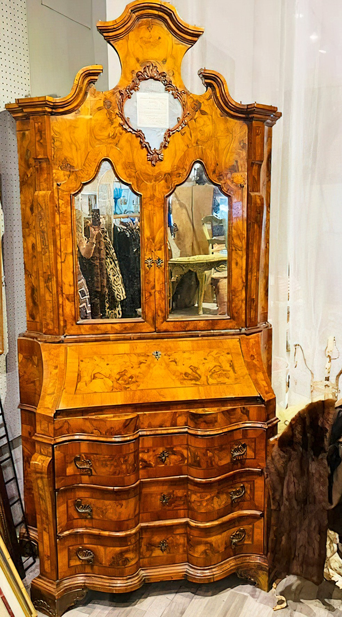 This isn't just furniture—it's functional art. The honey-toned wood and ornate detailing of this antique cabinet showcase craftsmanship from a bygone era.