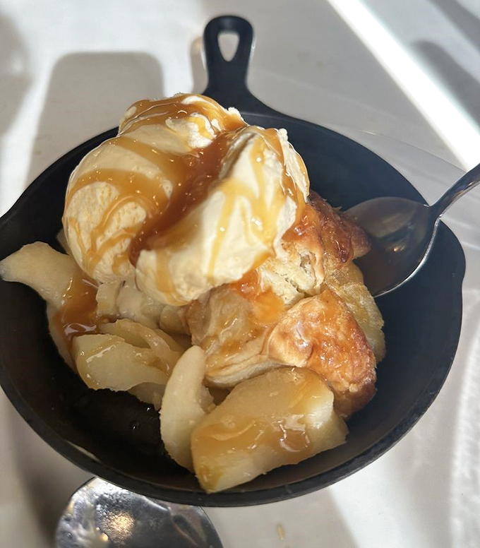 The apple dumpling arrives like a sweet Southern debutante, dressed in vanilla ice cream and caramel finery.