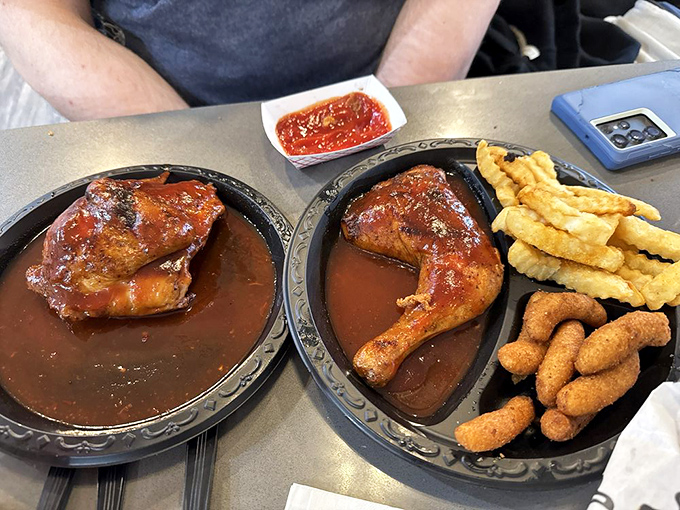 Sauce-slathered barbecue chicken quarters swimming in their own delicious juices—proof that simplicity often delivers the most profound flavors.