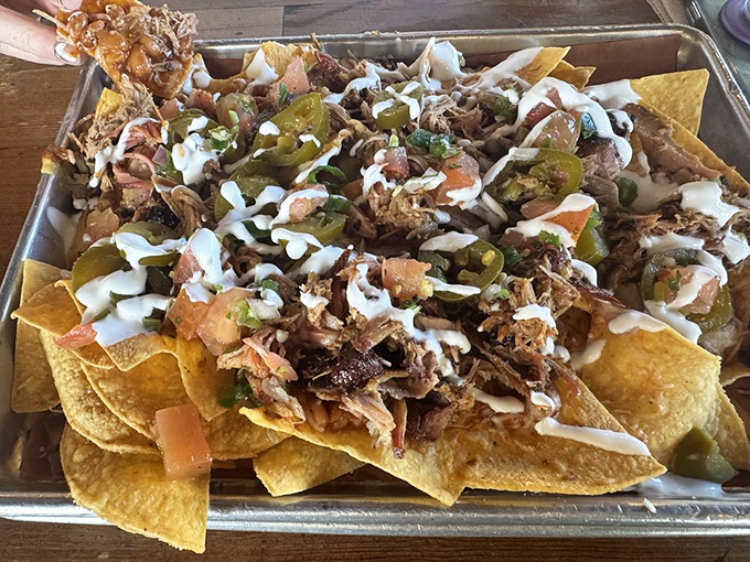 Nachos just got a PhD in deliciousness with this towering monument to barbecue creativity and cheese.