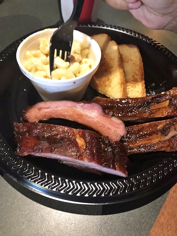 These ribs have that perfect pink smoke ring that separates the barbecue masters from the pretenders. The mac and cheese isn't just a side &ndash; it's a co-star.
