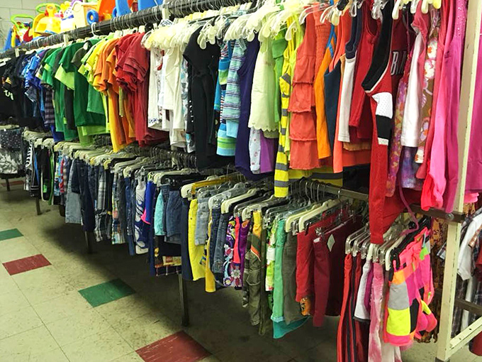 A rainbow explosion of tiny garments awaits parents who understand that kids outgrow clothes faster than ice cream melts in August.