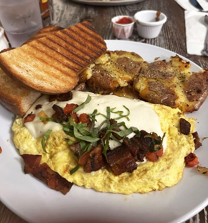 An omelet that doesn't just sit there looking pretty, but brings the party with fresh herbs, perfectly diced bacon, and a supporting cast of roasted potatoes.