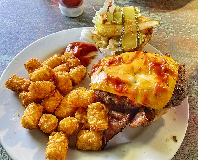 This isn't just a burger&mdash;it's an architectural masterpiece of beef, cheese, and tater tots that makes you question why anyone would eat anything else.