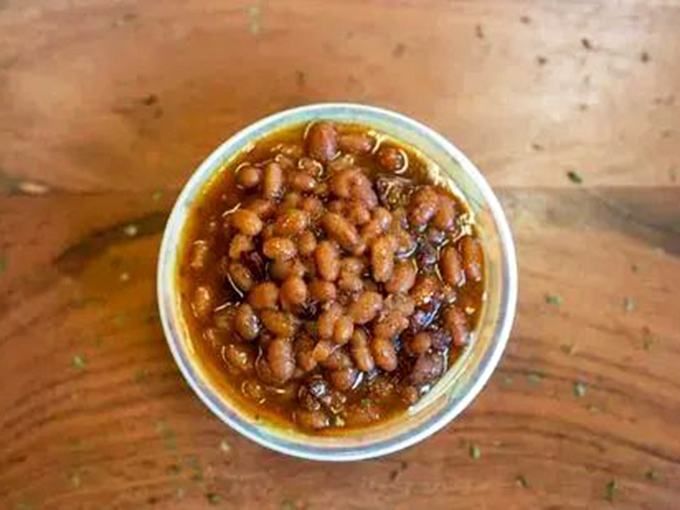 The legendary baked beans &ndash; swimming in a sauce that's had a long, meaningful relationship with smoke and meat drippings. Worth the trip alone.