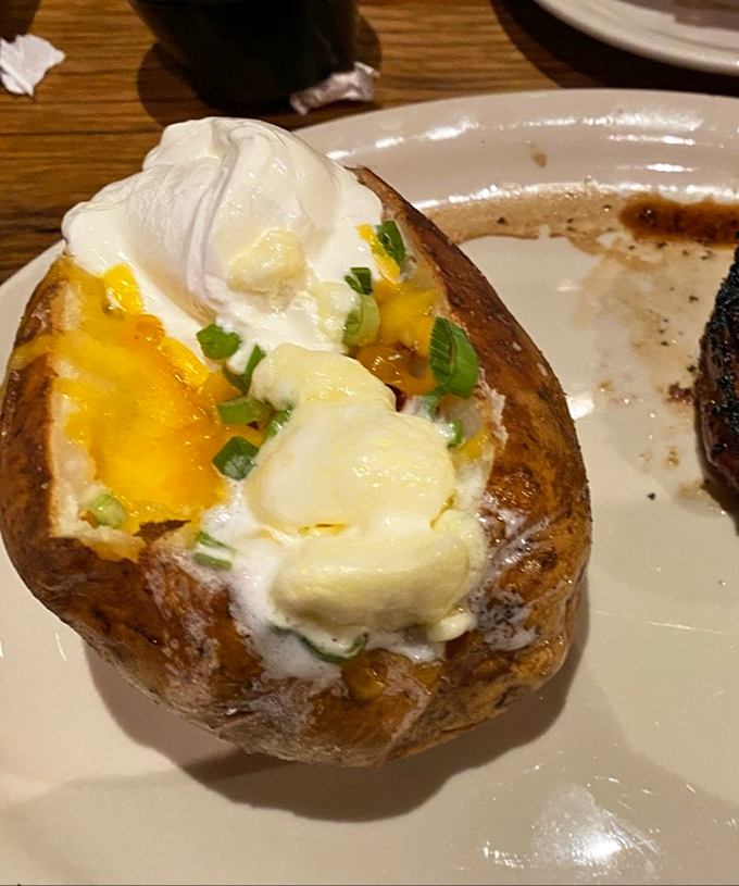 Behold the humble baked potato, transformed into a loaded masterpiece that could make a vegetarian question their life choices.