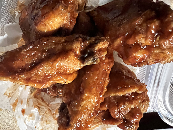 Sticky fingers required! These glistening wings demand you abandon all pretense of neatness and surrender to their saucy embrace.