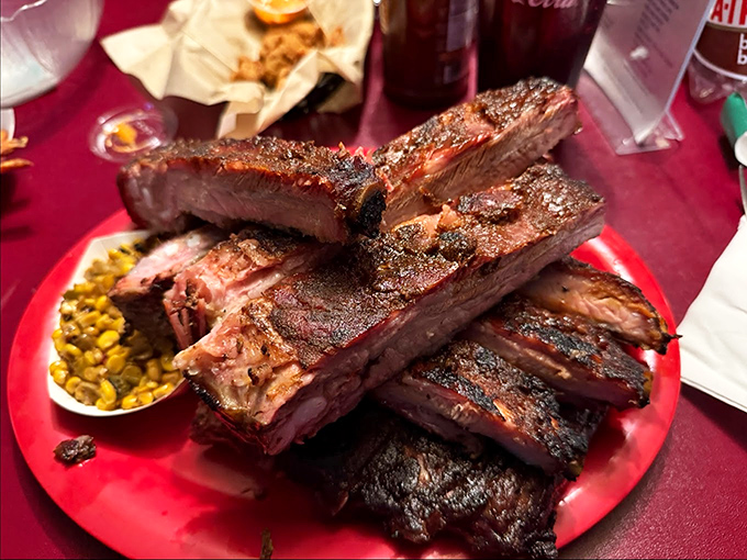 Architecture in its most delicious form—ribs stacked like meaty skyscrapers alongside golden corn. This isn't just dinner; it's edible engineering at its finest.