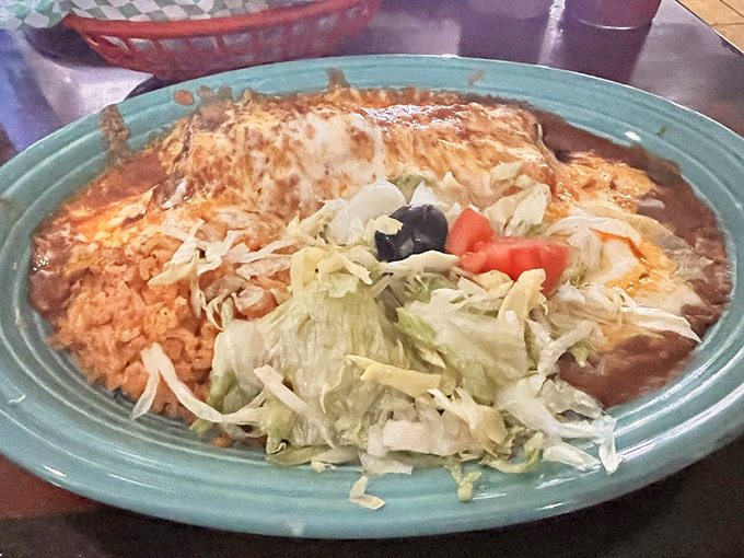 Behold the chimichanga in its natural habitat&mdash;swimming in enchilada sauce, topped with lettuce, and practically begging to be devoured.