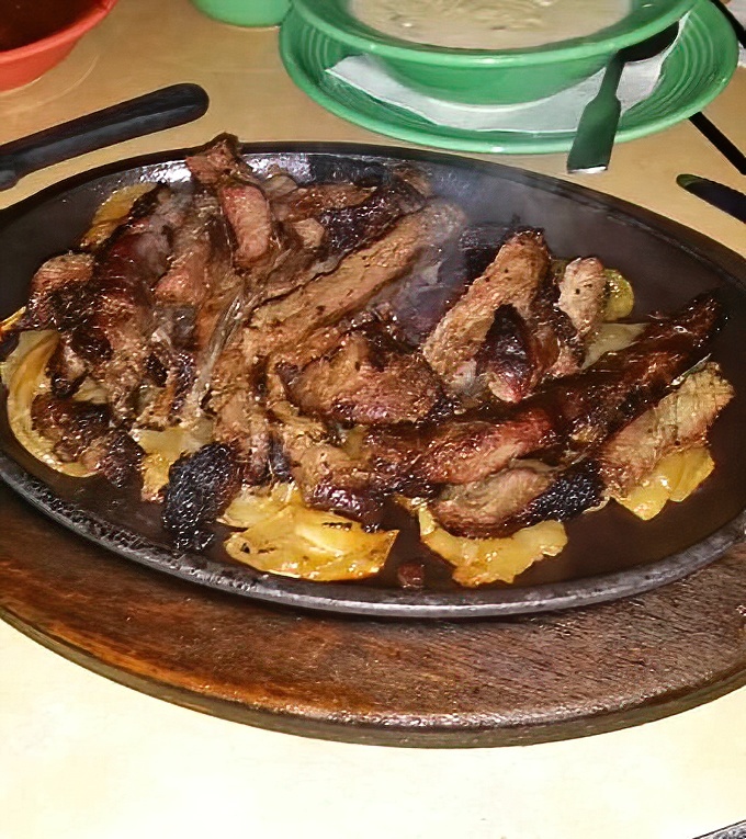 Sizzling beef fajitas deliver that theatrical entrance that never gets old, no matter how many times you've seen it.