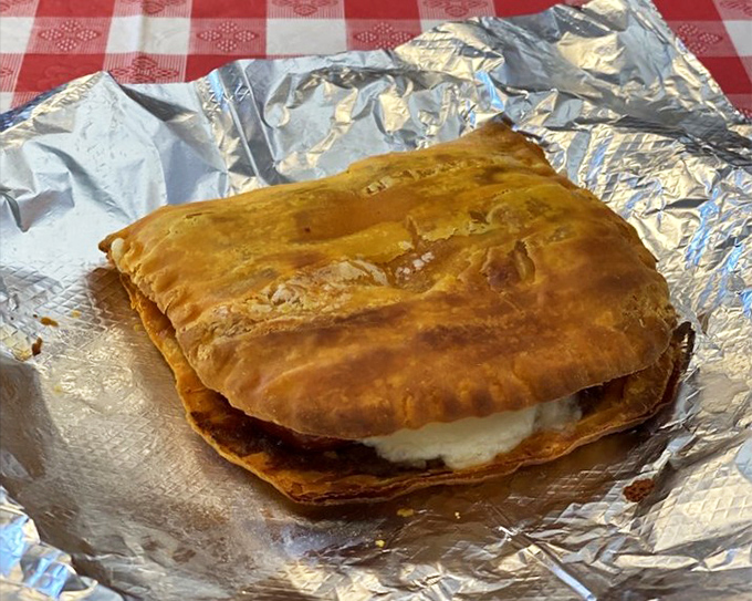 This calzone isn't playing around &ndash; it's the heavyweight champion of hand-held Italian delights, with a side of marinara for good measure. 