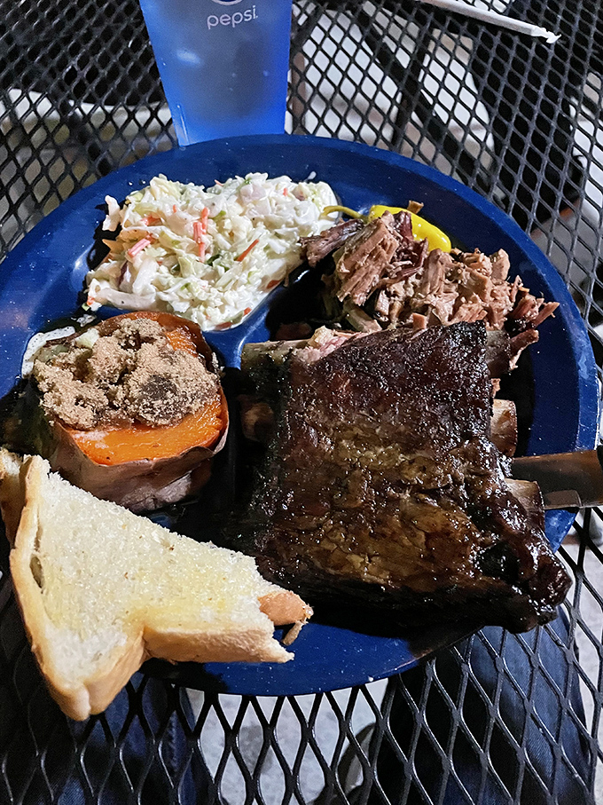 Ribs so perfectly charred they should be in a barbecue museum, paired with coleslaw that cuts through the richness like a cool breeze.