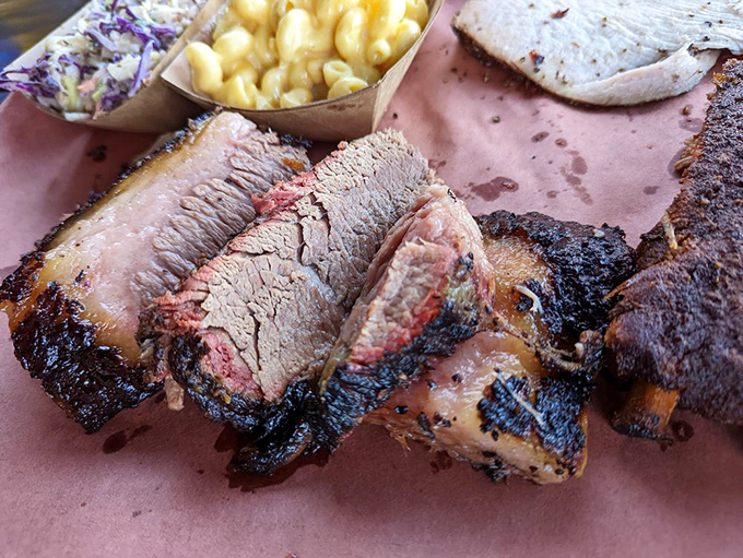 Brisket with a smoke ring so perfect it could be framed in a museum. The pink interior against that blackened crust is nature's most beautiful contrast.