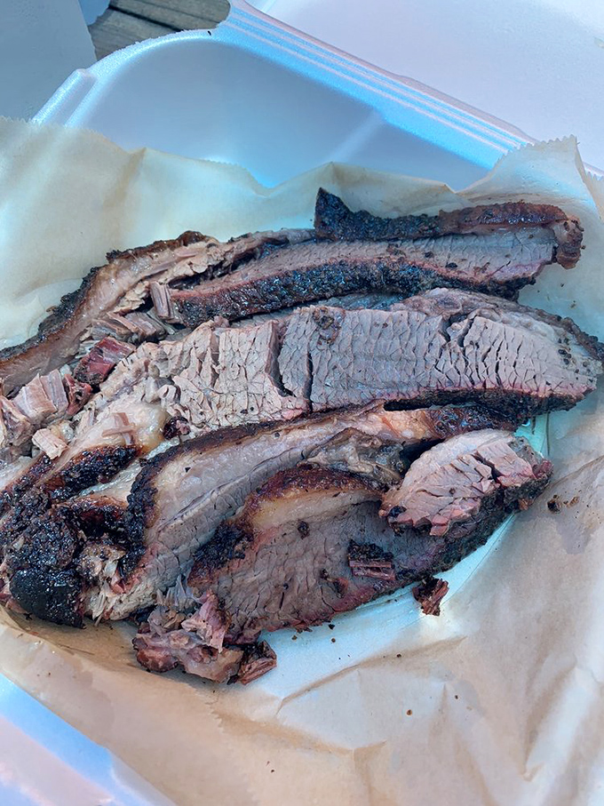 Beef brisket sliced thick enough to make Texas jealous, with that perfect pink smoke ring.