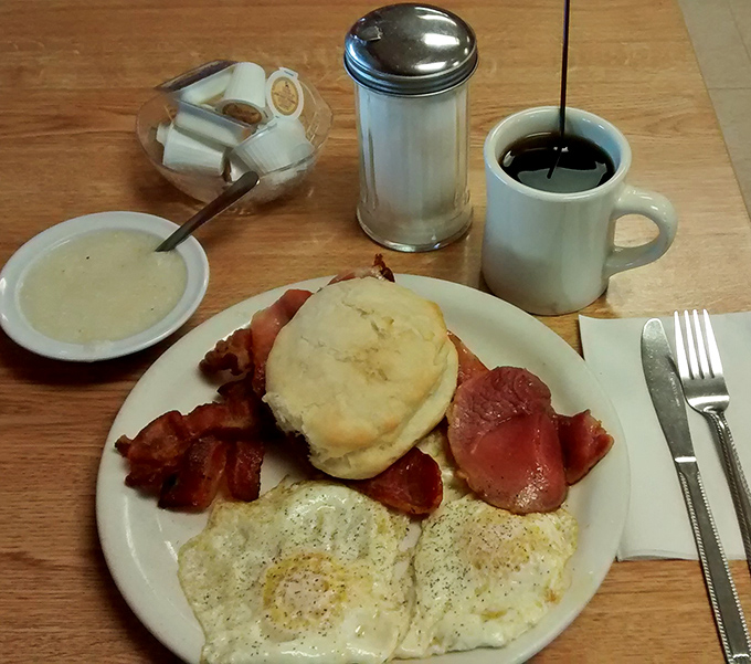 Breakfast of champions! Two sunny-side-up eggs, crispy bacon, and a biscuit that would make your grandmother both proud and jealous.