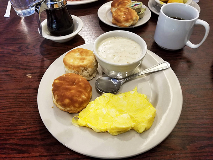 Breakfast nirvana: fluffy biscuits, creamy gravy, and eggs that practically glow. The holy trinity of morning satisfaction on a single plate.