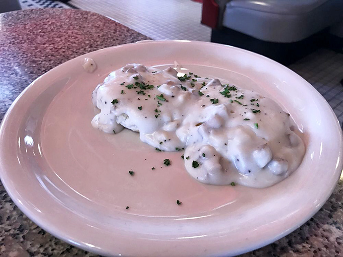 These biscuits and gravy look like they've been practicing for their close-up—creamy, peppery perfection that grandma would approve of.