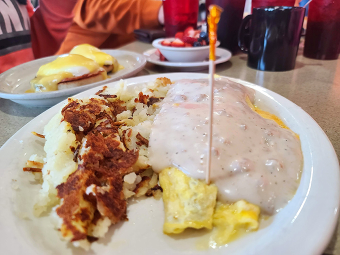Biscuits and gravy: the breakfast equivalent of a warm hug from your favorite grandparent, complete with crispy hash browns on the side.