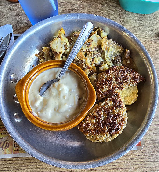 Comfort on a plate: creamy gravy, golden biscuits, and home fries that could make a grown adult weep with joy.