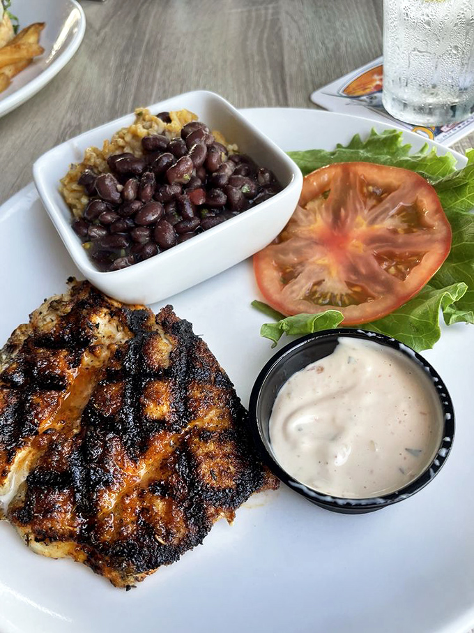 Blackened to perfection, this fish wears its seasoning like a badge of honor, while those black beans might just steal the show.