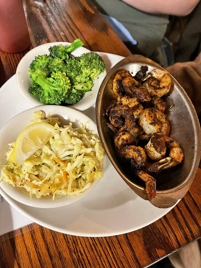 Blackened shrimp that's had just the right conversation with fire, served with slaw that brings the tang and broccoli for your conscience.