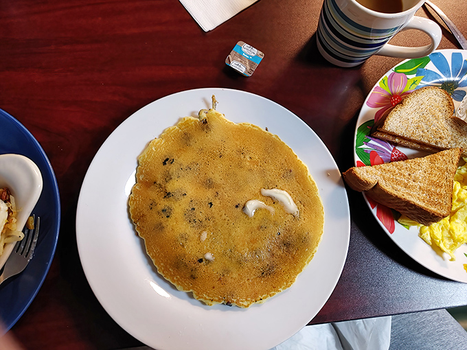 Blueberry pancakes stacked high enough to require structural engineering approval and syrup distribution strategy.