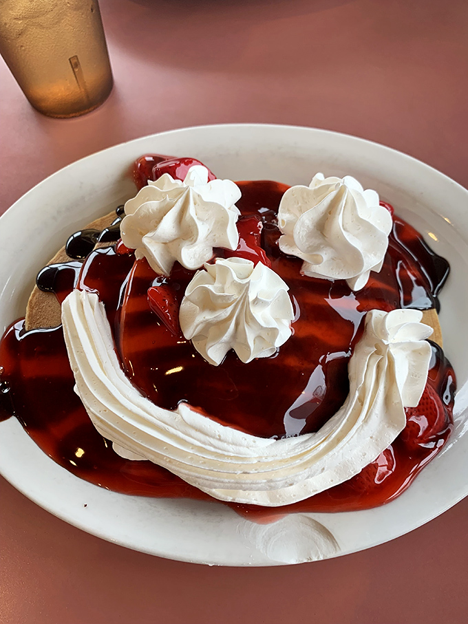 A cherry-topped dessert that makes you question why we don't start every day with whipped cream and fruit sauce.