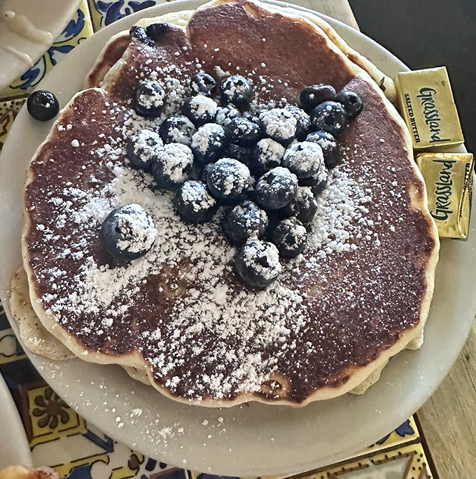Pancakes the size of vinyl records topped with powdered sugar and blueberries. Breakfast or dessert? The line deliciously blurs.