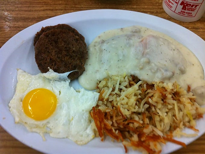 The breakfast trinity: perfectly cooked egg, crispy hash browns, and a meat patty that didn't come from a freezer. Hallelujah!