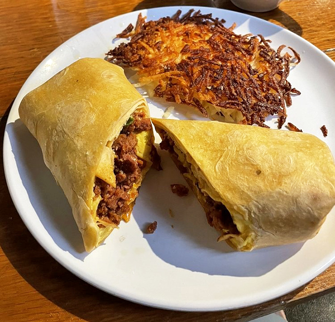 The breakfast burrito&mdash;where morning ingredients gather for a flavor party wrapped in a tortilla blanket, with crispy hash browns standing guard.