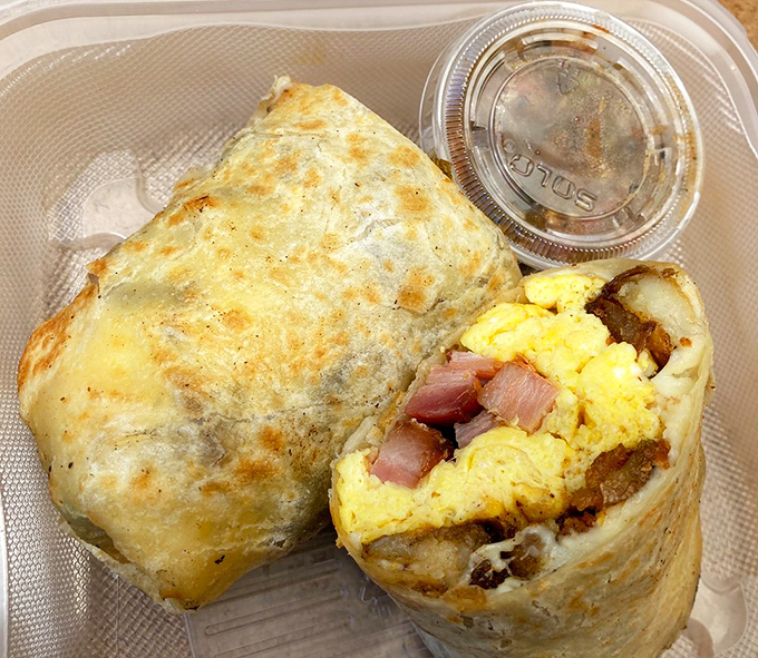 Breakfast burritos should always look like this &ndash; a golden package revealing scrambled eggs, potatoes, and thick-cut bacon that makes morning meetings completely optional.