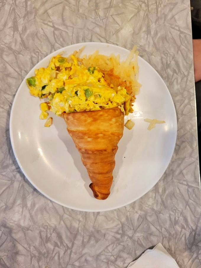 Breakfast reimagined! Scrambled eggs nestled in a golden croissant cone&mdash;proof that thinking outside the plate leads to morning magic.