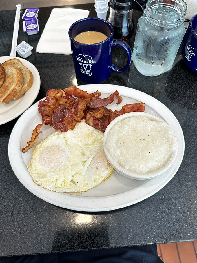 The breakfast trinity: perfectly cooked eggs, bacon with that ideal crisp-to-chew ratio, and grits that would make a Southerner nod in approval. 