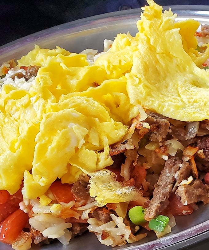 Breakfast skillet heaven – where eggs, meat, and hash browns unite in a glorious morning symphony. The kind of hearty breakfast that fuels Michigan's hardworking souls.