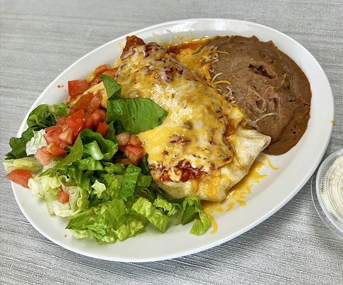 A breakfast burrito that's dressed for success &ndash; smothered in cheese, topped with eggs, and accessorized with fresh greens. Knife and fork required.