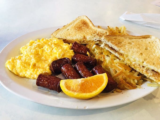 Breakfast harmony achieved: scrambled eggs that actually taste like eggs, sausage links with perfect snap, and hash browns crisped to golden perfection.