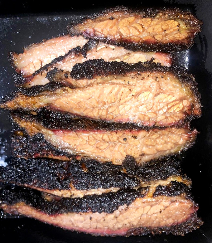 Brisket so perfectly rendered it makes you wonder if there's a barbecue whisperer hiding somewhere behind the smoker.