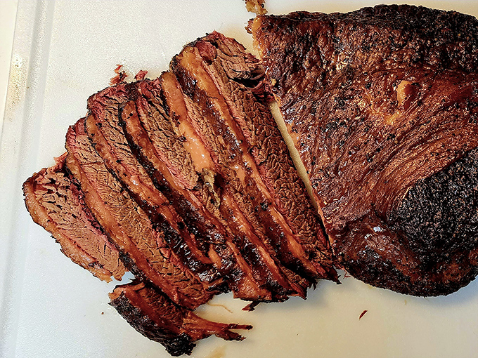 Brisket sliced against the grain reveals the telltale pink smoke ring – nature's way of saying "patience rewarded" in the language of barbecue.