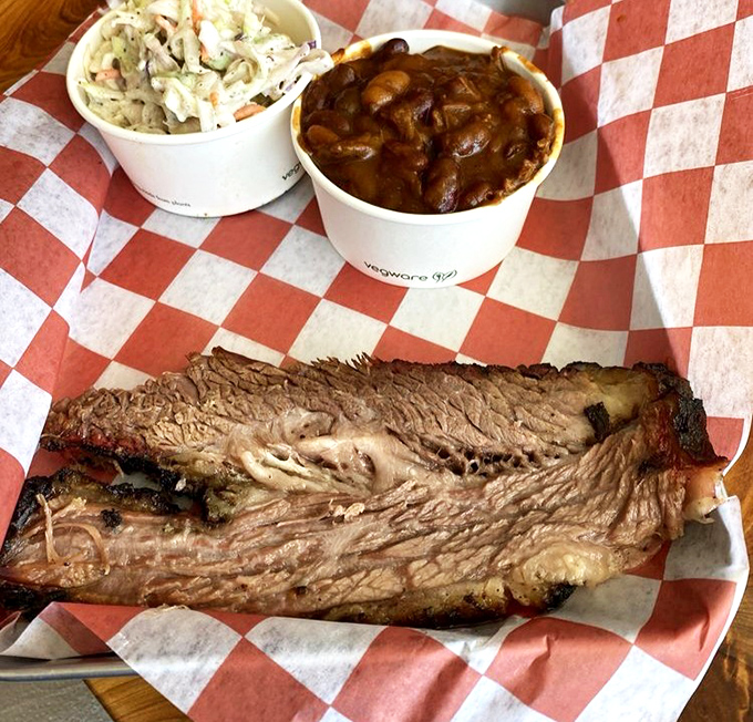 Brisket that would make a Texan weep tears of joy, paired with sides that understand their assignment. This is meat meditation at its finest.