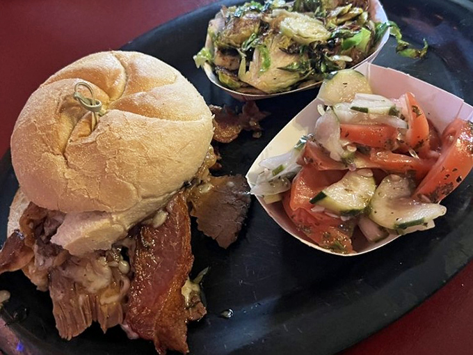 A proper brisket sandwich should require both hands and several napkins. This beauty, with its crisp vegetables, delivers on that sacred promise.