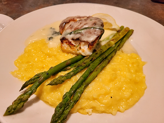 The bronzed Chilean sea bass perched atop golden risotto with asparagus spears is like the seafood equivalent of winning the lottery.