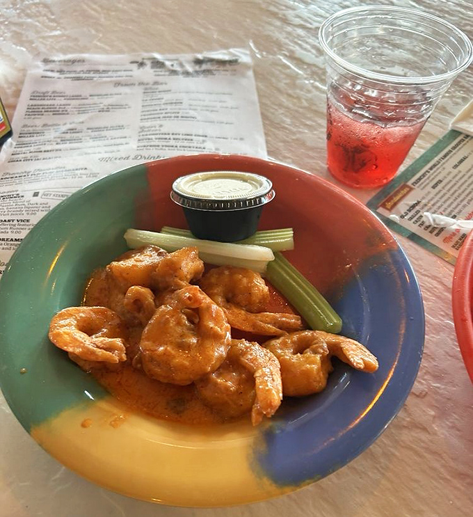 Buffalo shrimp that bring the heat but know their manners, served with cooling celery sticks for that perfect flavor balance.
